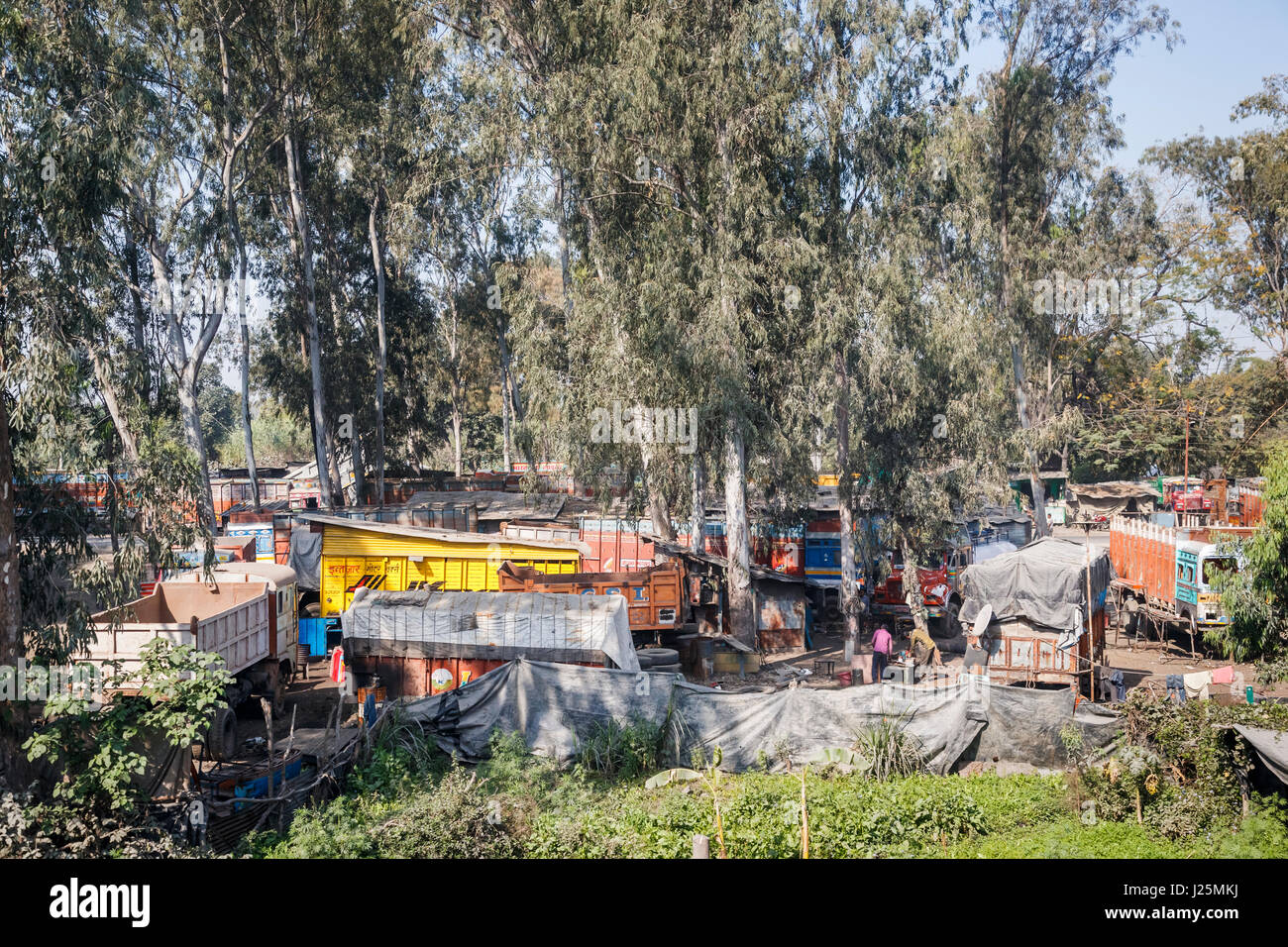 Lorries being repaired at a roadside lorry park repair yard, Rudrapur ...