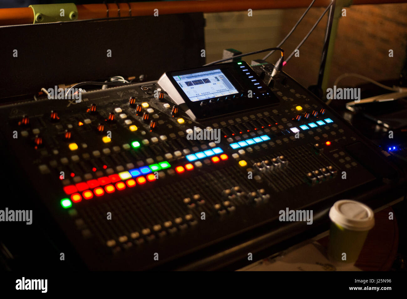 Detail of mixing desk with lights on in dark venue Stock Photo - Alamy