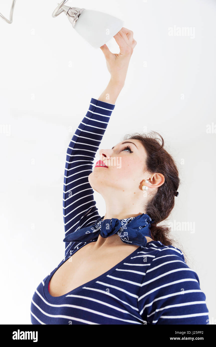 pretty woman mount a new light bulb in the socket Stock Photo - Alamy