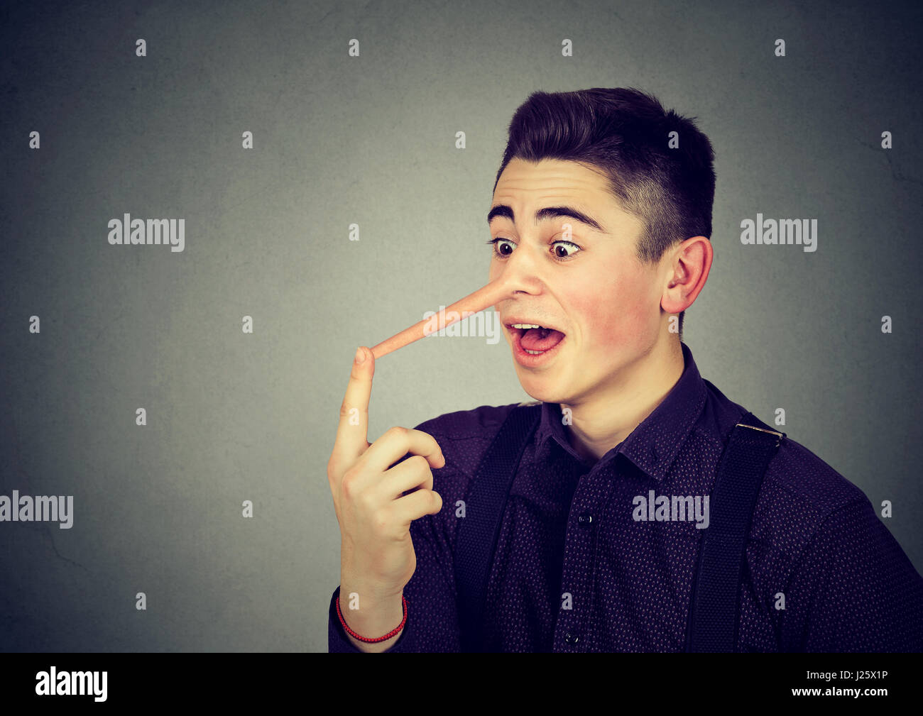Man with long nose isolated on grey wall background. Liar concept Stock ...