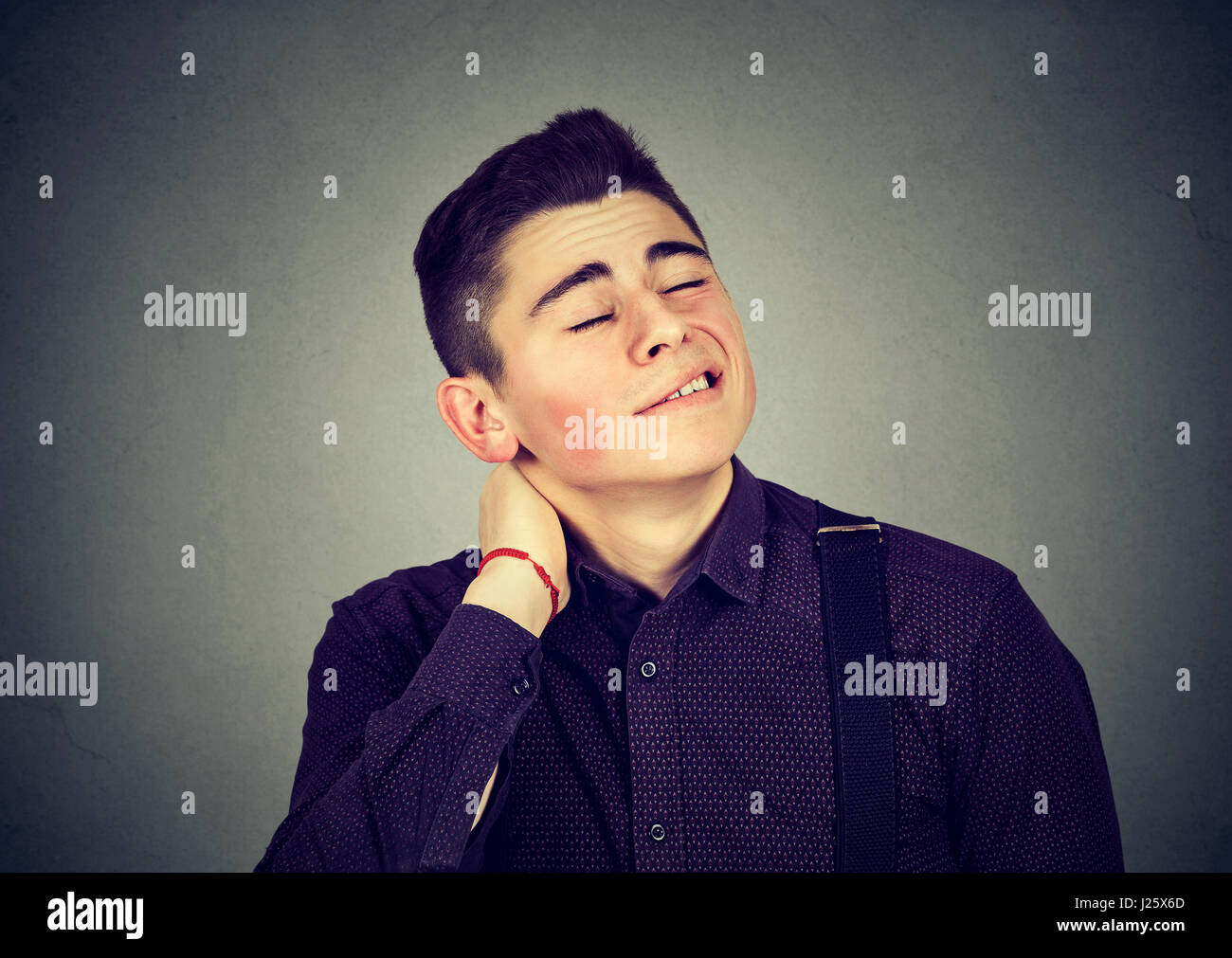 Young man having neck pain Stock Photo - Alamy