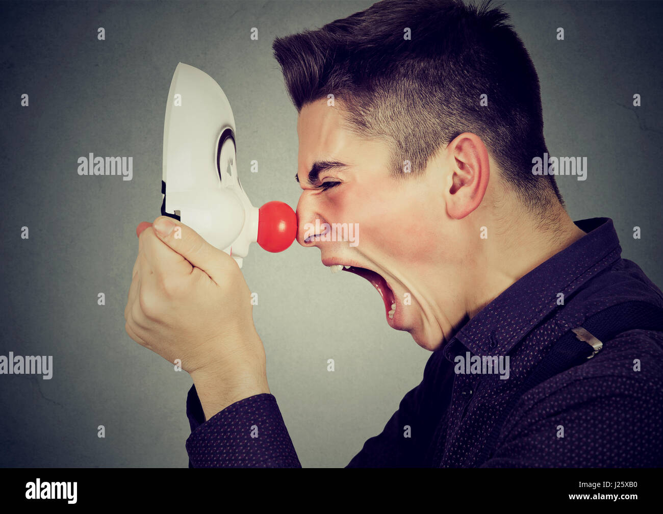 Side profile portrait angry man screaming at happy clown mask Stock ...