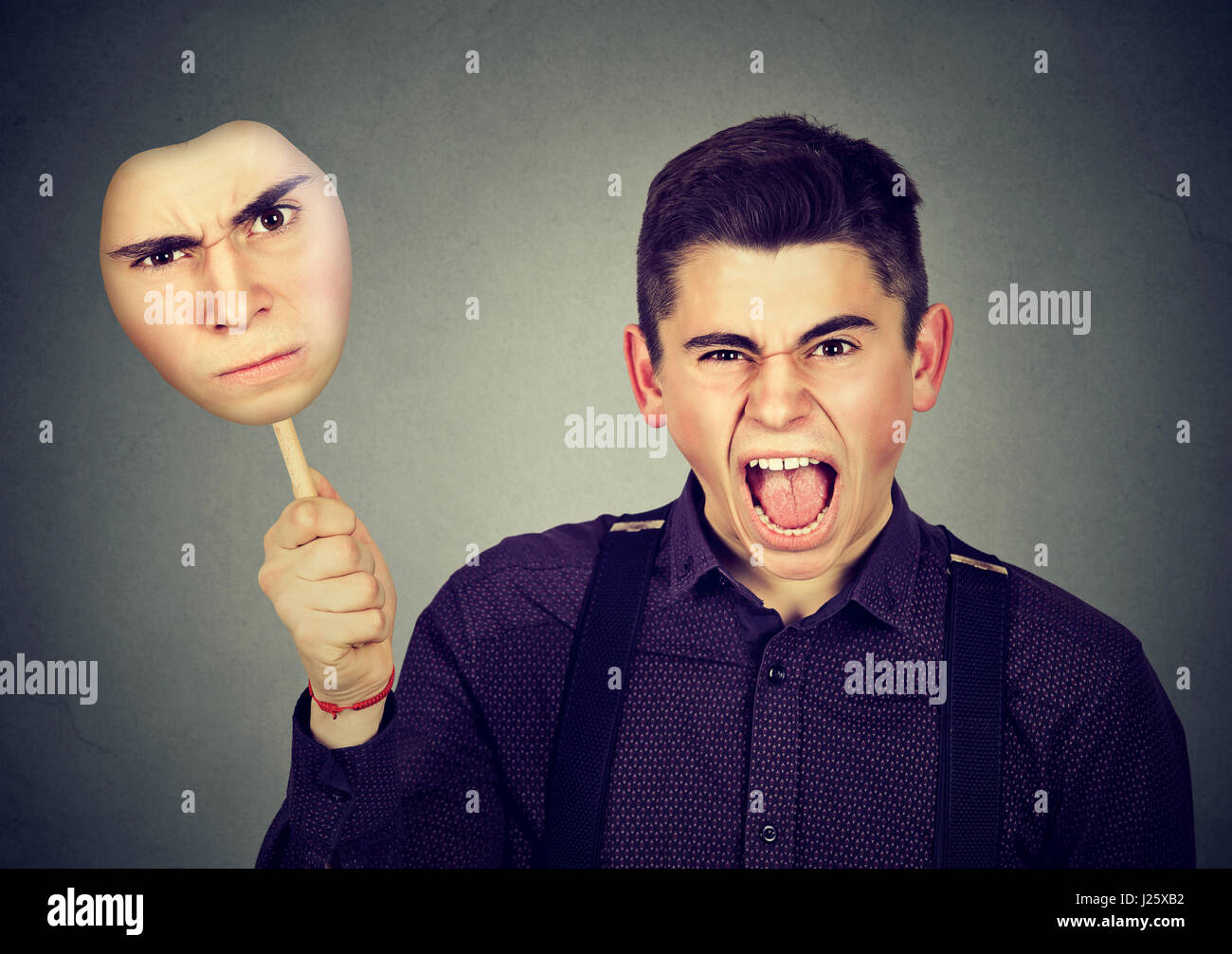 Angry man taking off mask with grumpy face expression Stock Photo - Alamy
