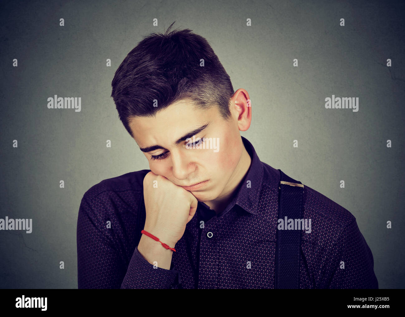 stressed sad man looking down isolated on gray wall background Stock ...