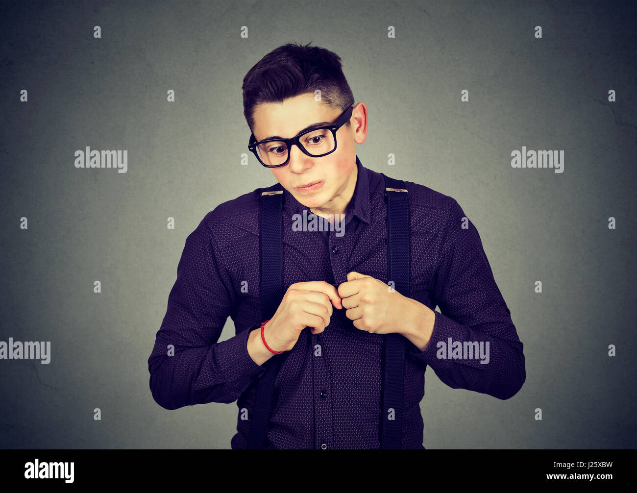 Portrait young man in unpleasant awkward situation playing nervously ...