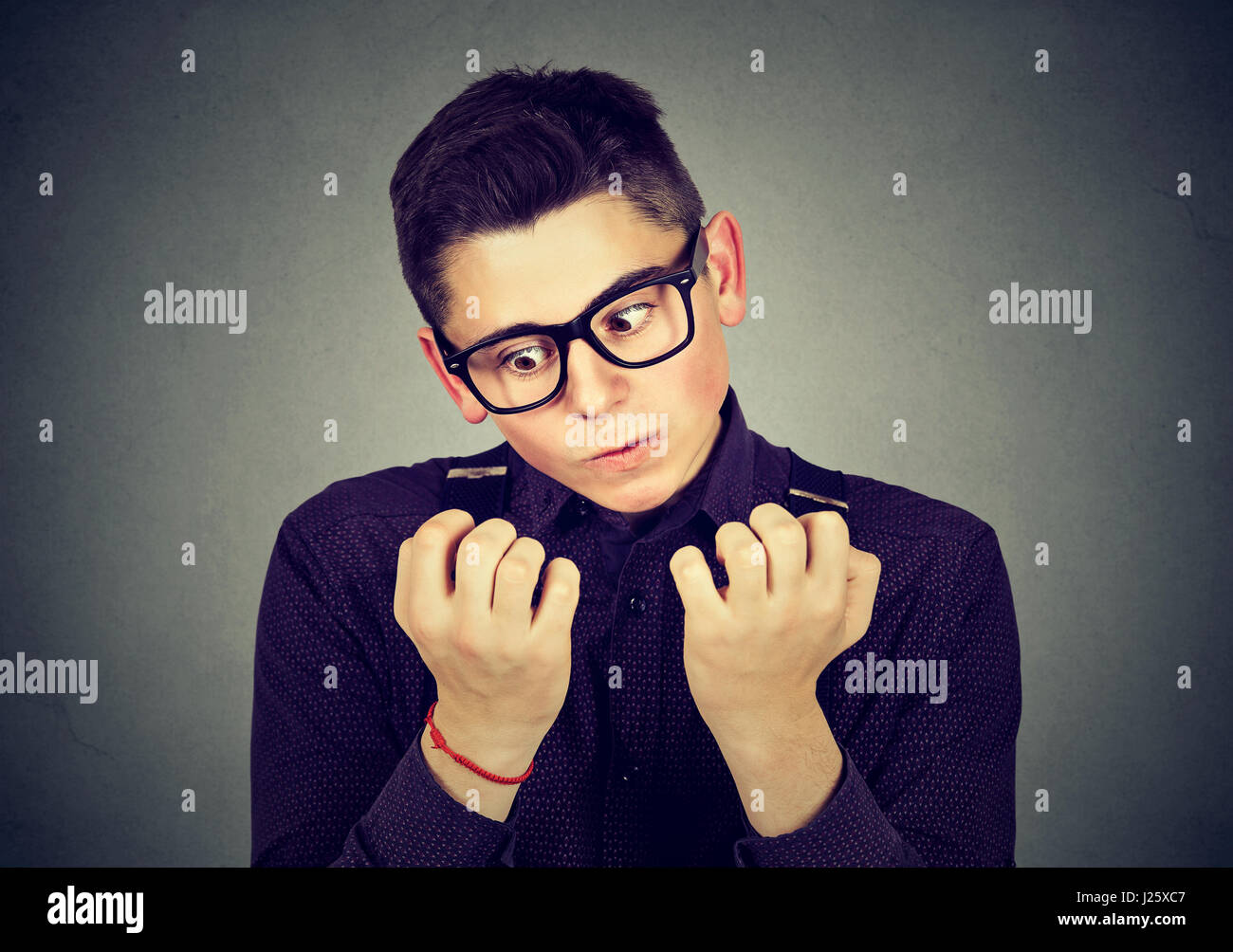 man looking at hands nails obsessing about cleanliness germs isolated ...