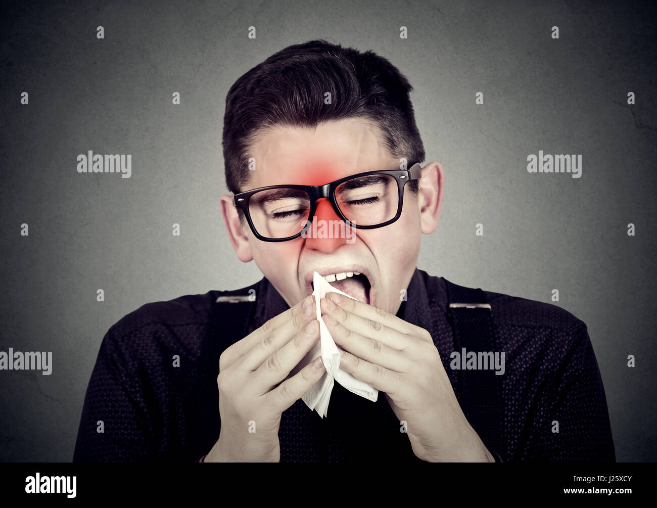Man with cold sneezing in tissue Stock Photo - Alamy