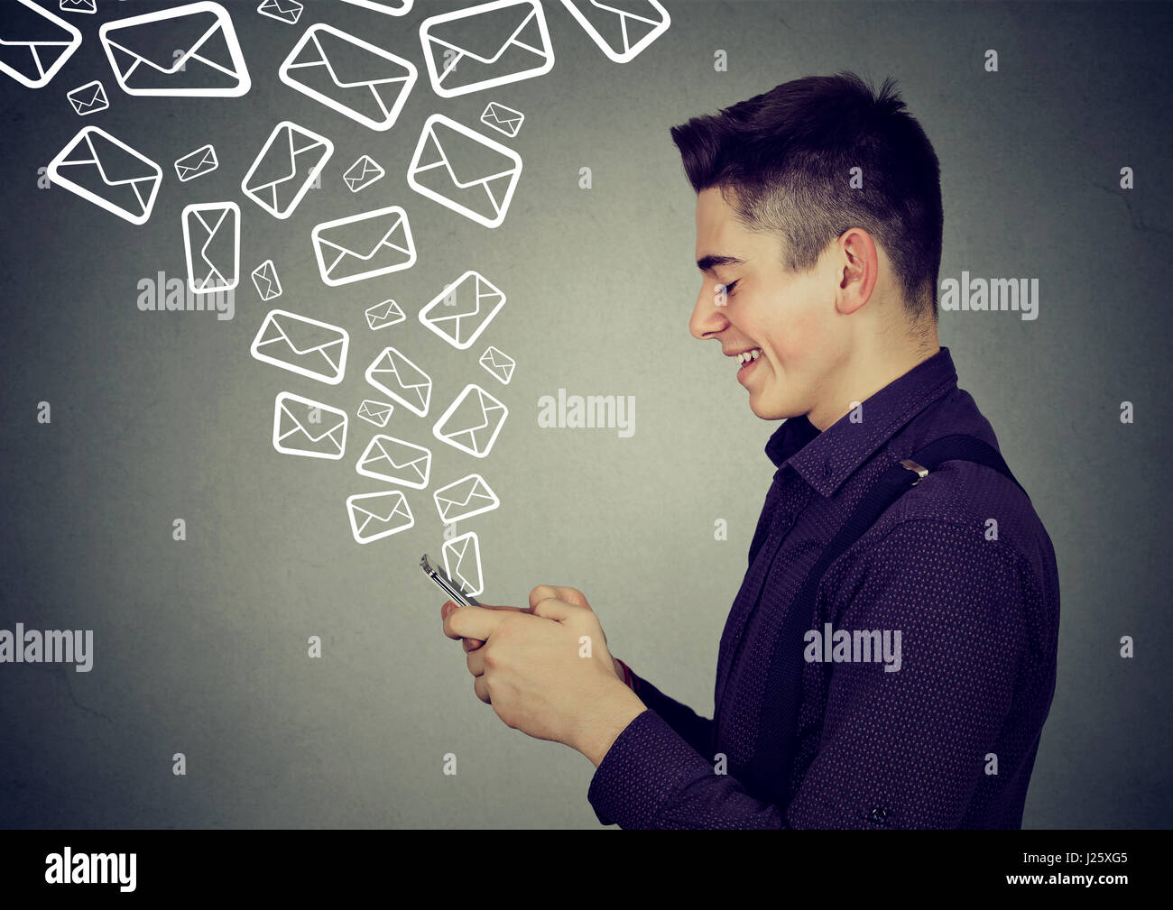 Side profile man busy sending messages on smart phone email icons ...
