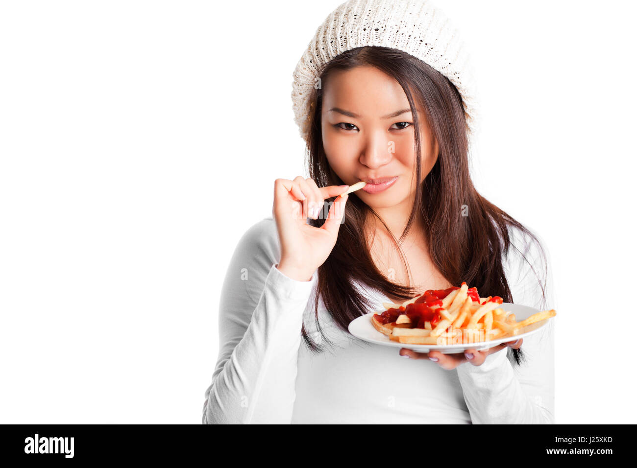 An isolated shot of an asian girl eating french fries Stock Photo - Alamy
