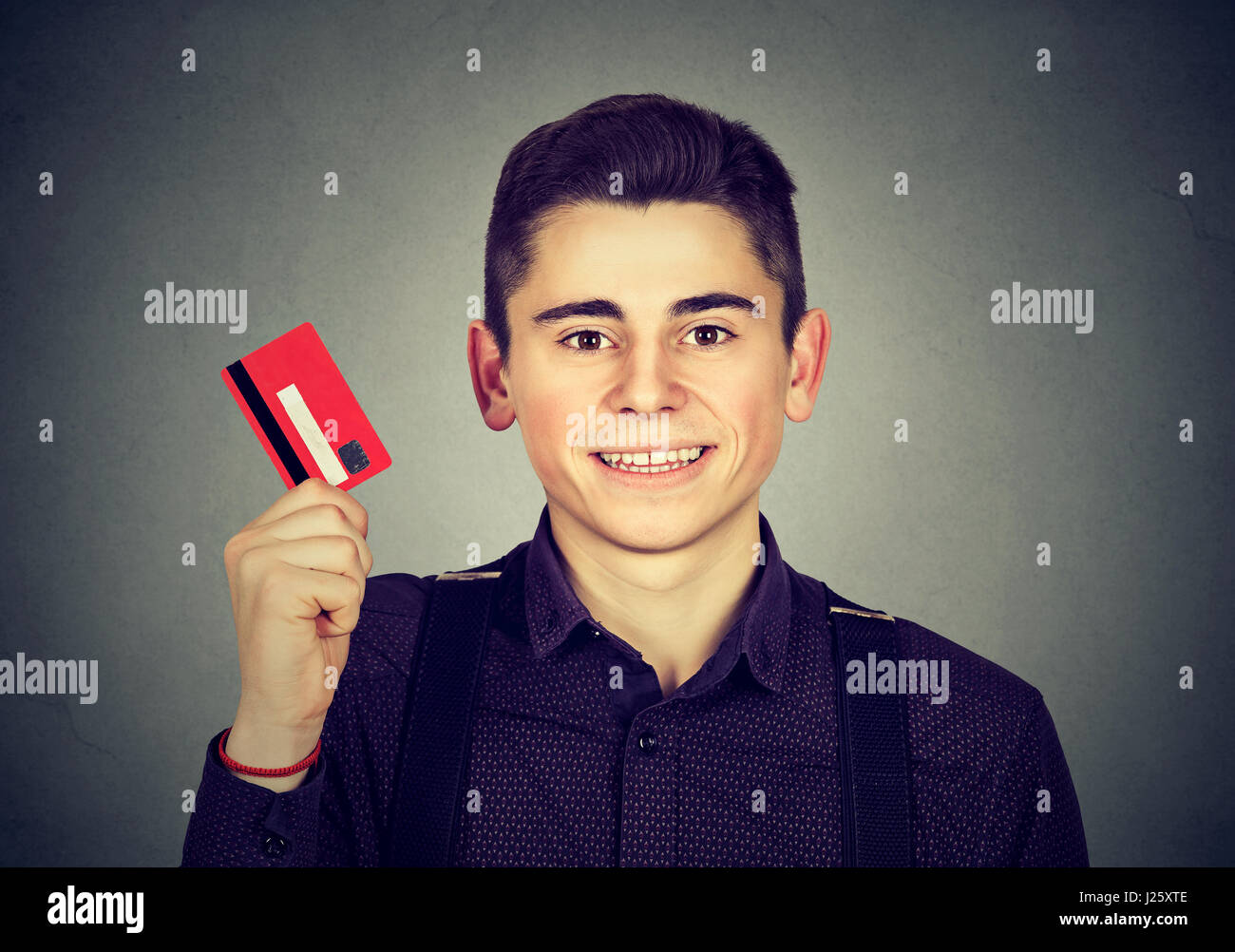 happy young man showing credit card Stock Photo - Alamy