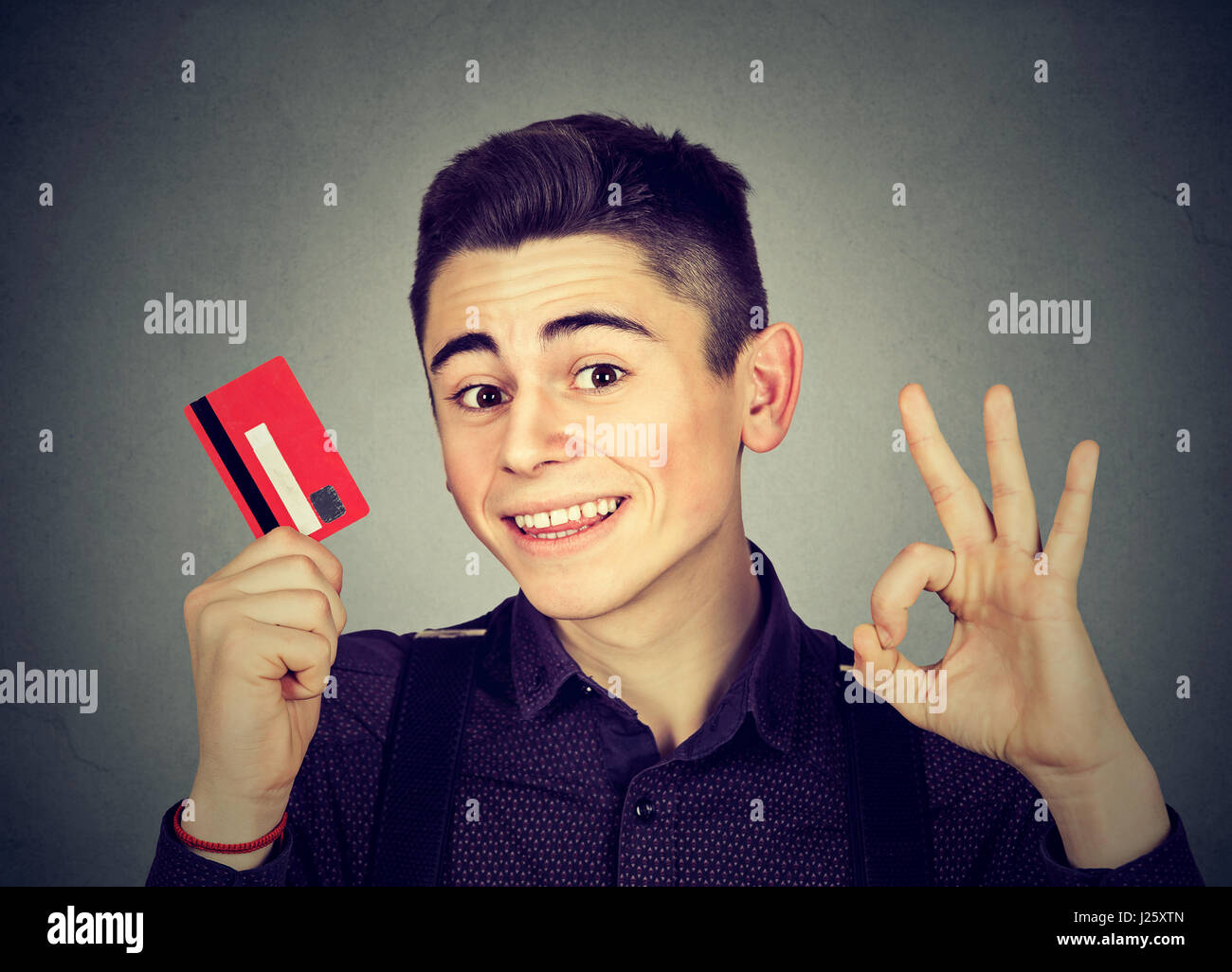 happy young man with credit card showing Ok sign Stock Photo - Alamy