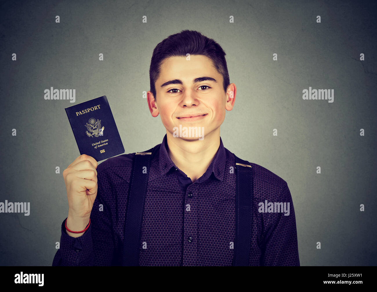 Portrait handsome young happy man with USA passport isolated on gray ...