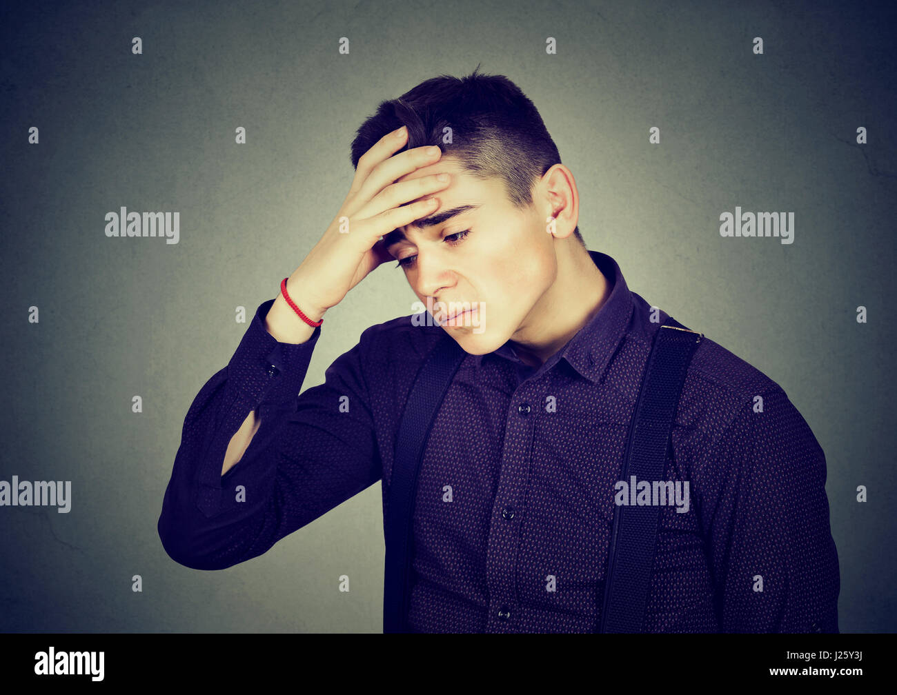 stressed sad man looking down isolated on gray wall background Stock ...