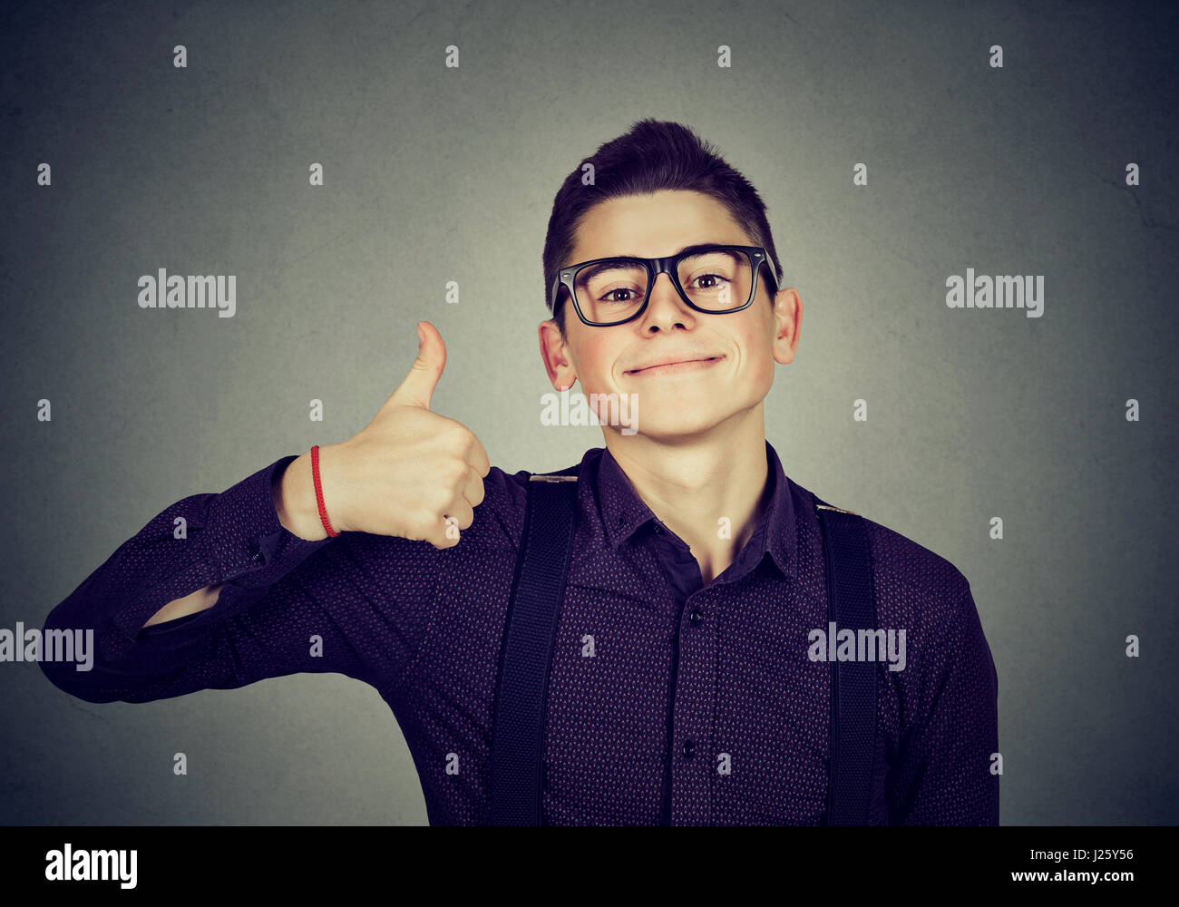 Successful teenager. Nerdy funny man giving thumbs up hand gesture sign ...