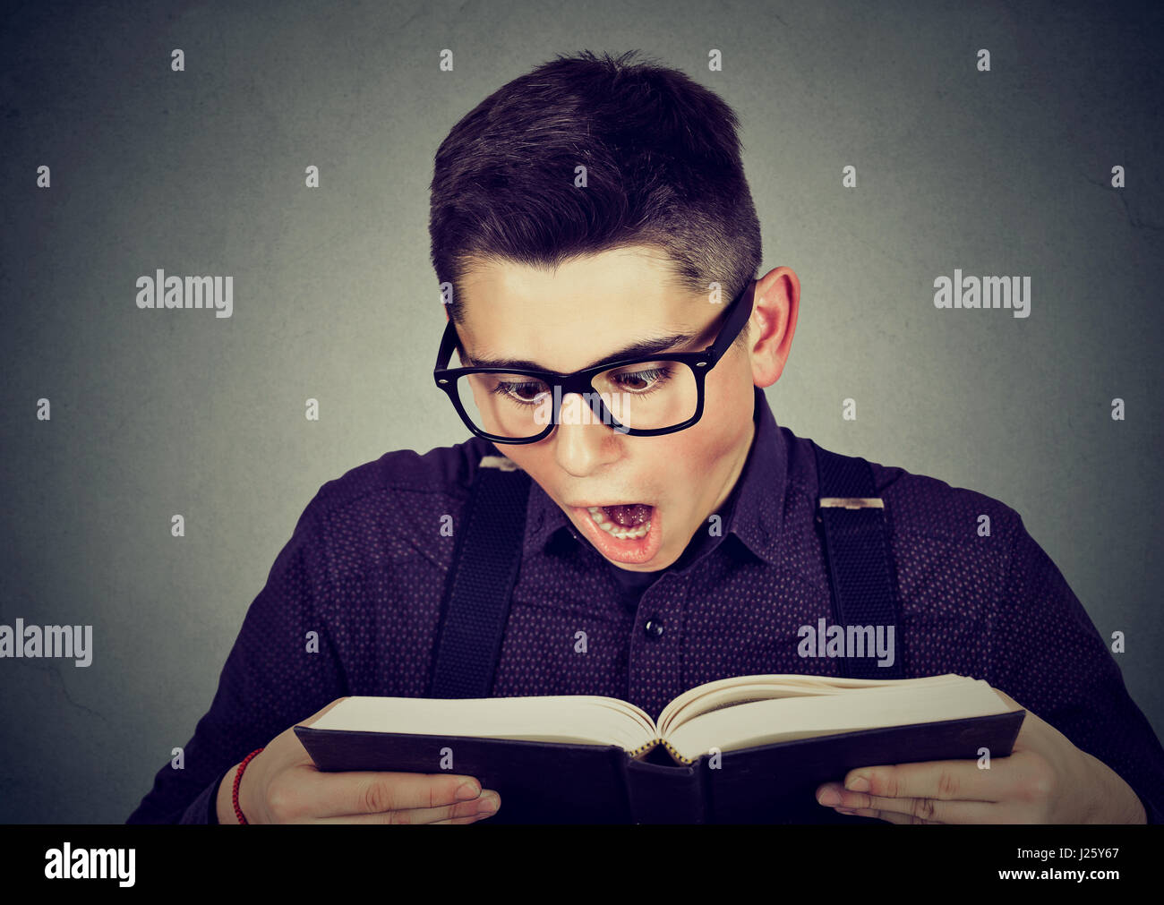 Amazed man reading a book Stock Photo - Alamy