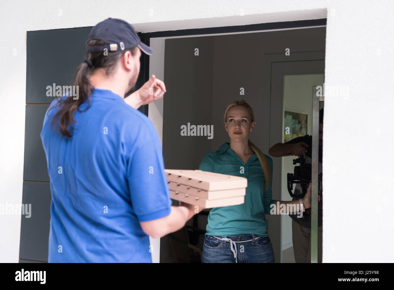 Pizza Delivery Man Giving Pizza Boxes To Smiling Young Woman Stock ...