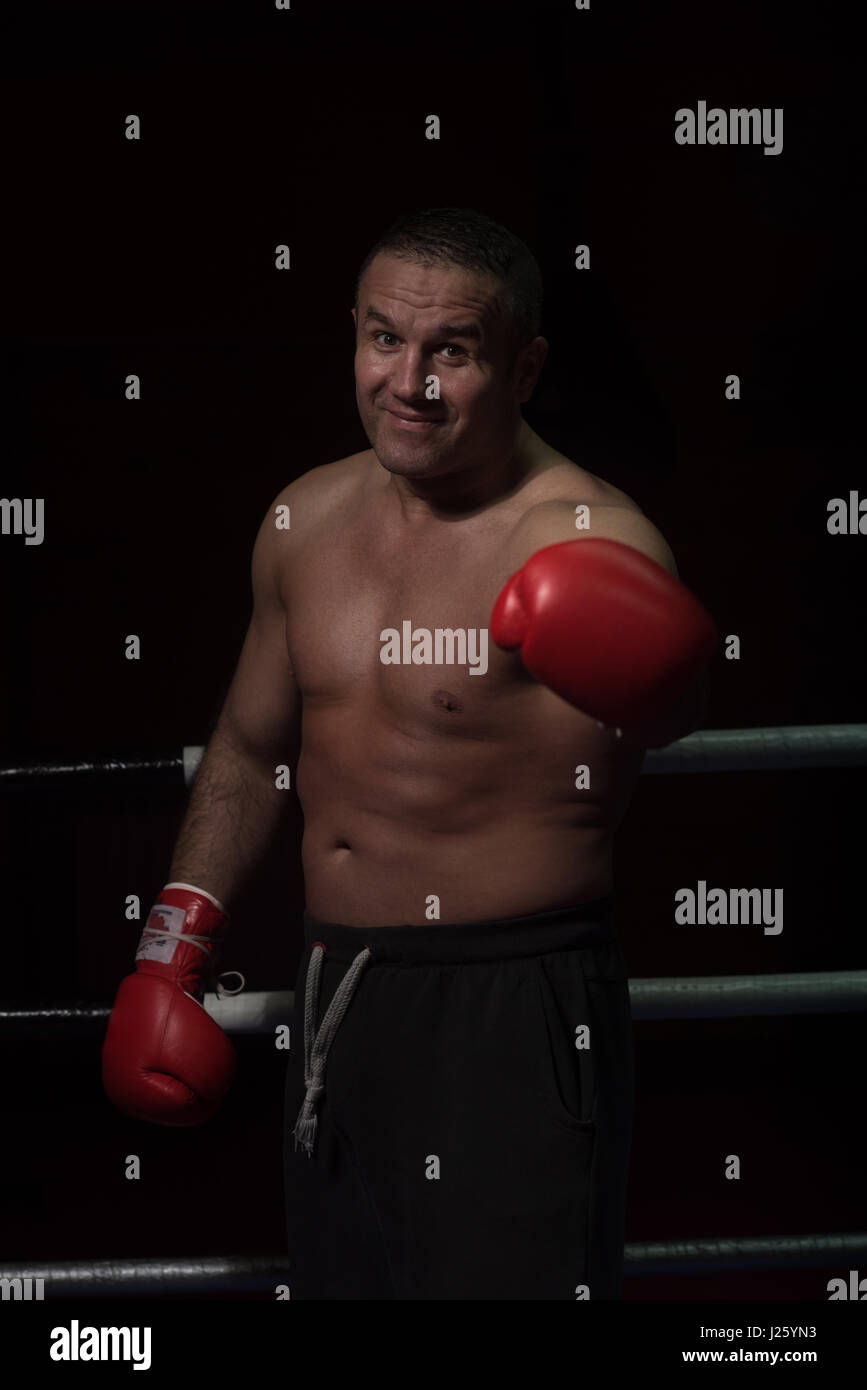 portrait of muscular professional kickboxer who standing in the ring ...
