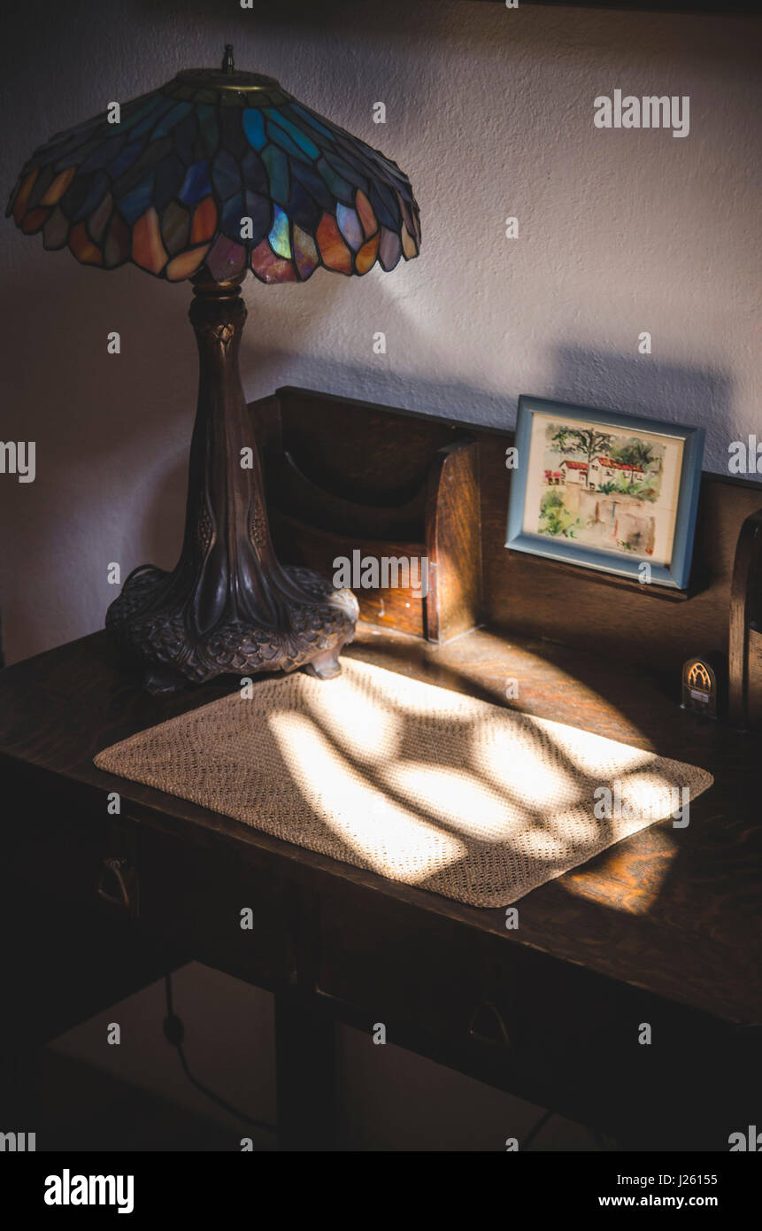 Light From Window on Small Writing Desk with Lamp in Shadows Stock ...