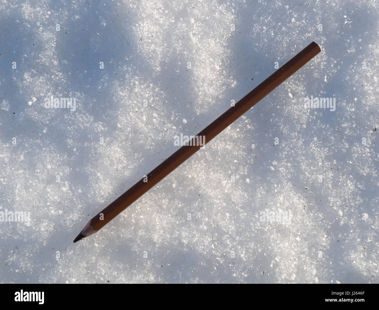 Pencil in the snow Stock Photo - Alamy
