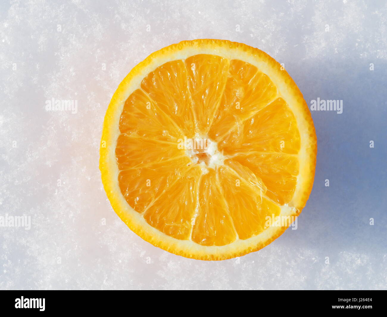 Orange in the snow Stock Photo - Alamy
