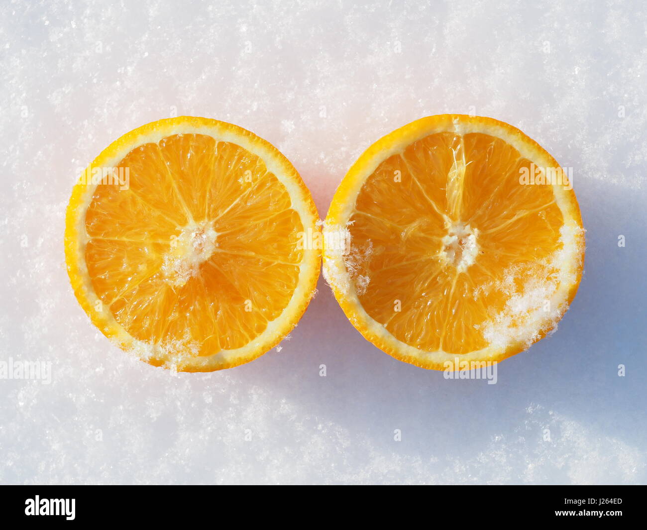 Orange in the snow Stock Photo - Alamy