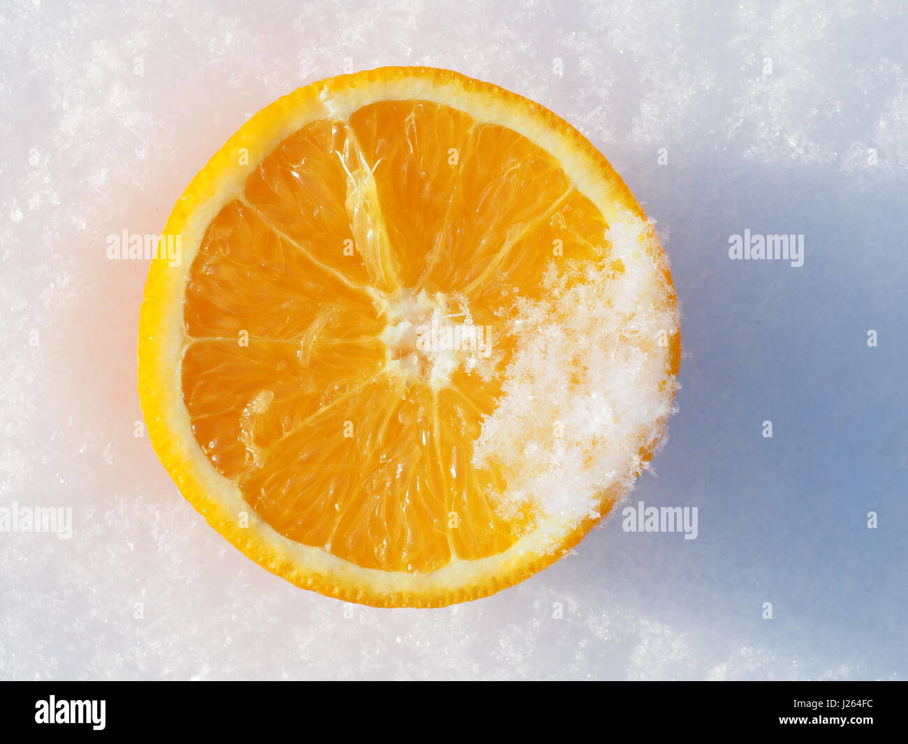 Orange in the snow Stock Photo - Alamy