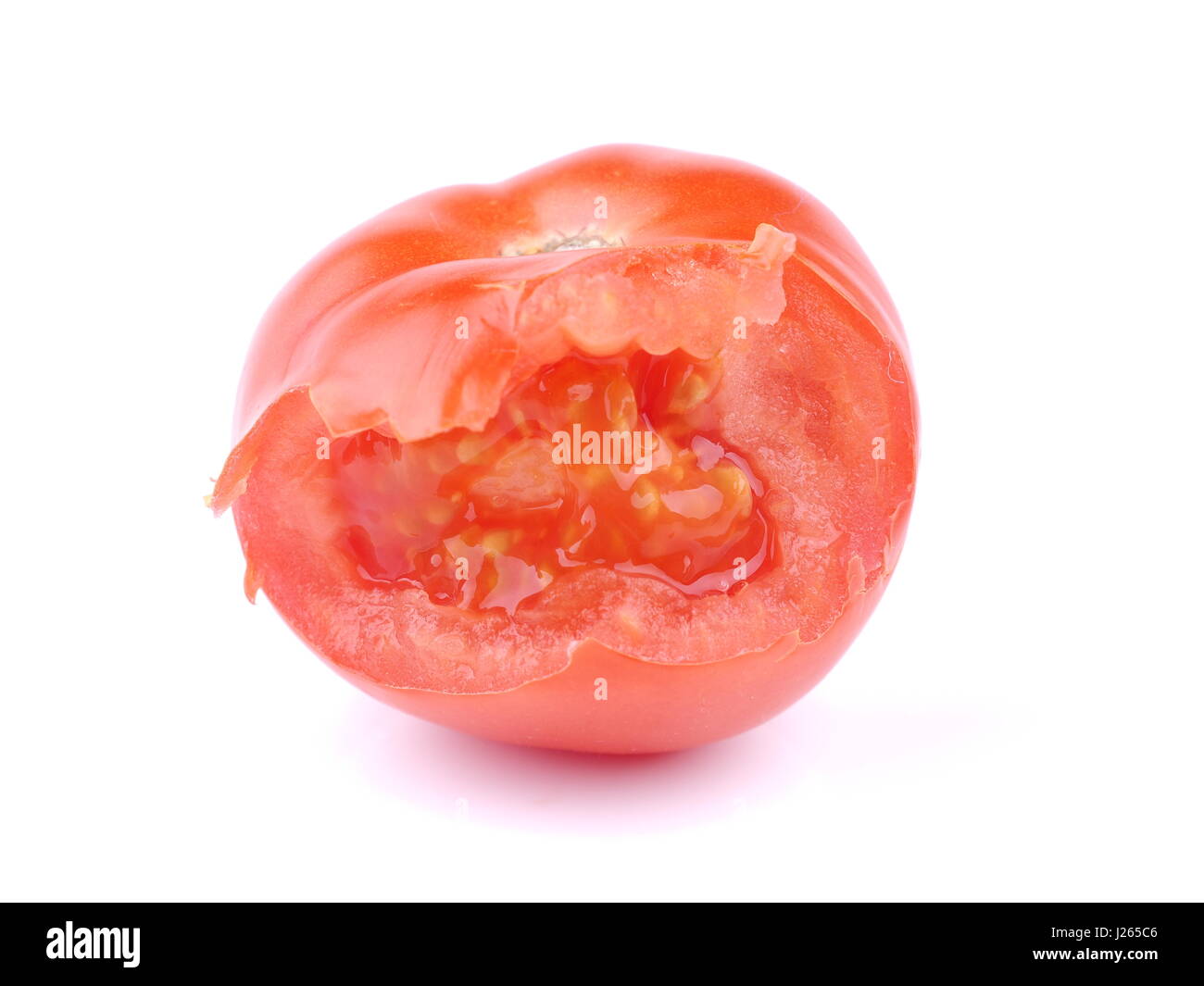 bitten red tomato on a white background Stock Photo - Alamy