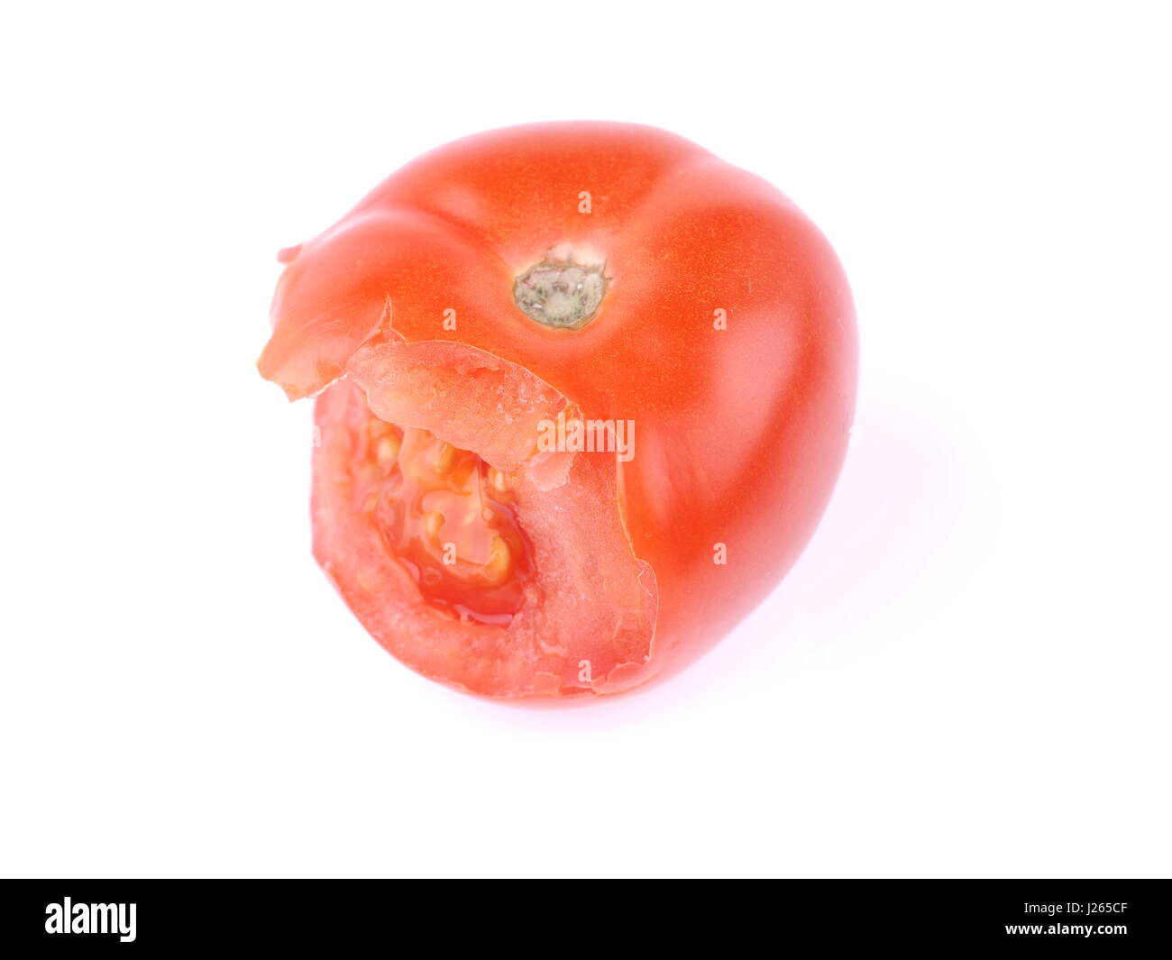 bitten red tomato on a white background Stock Photo - Alamy