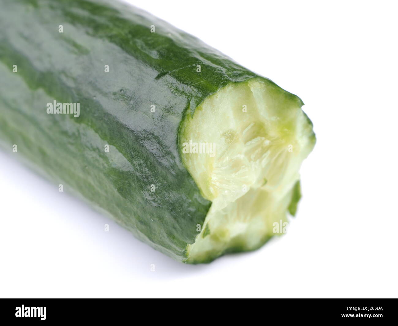 bitten green cucumber on a white background Stock Photo - Alamy