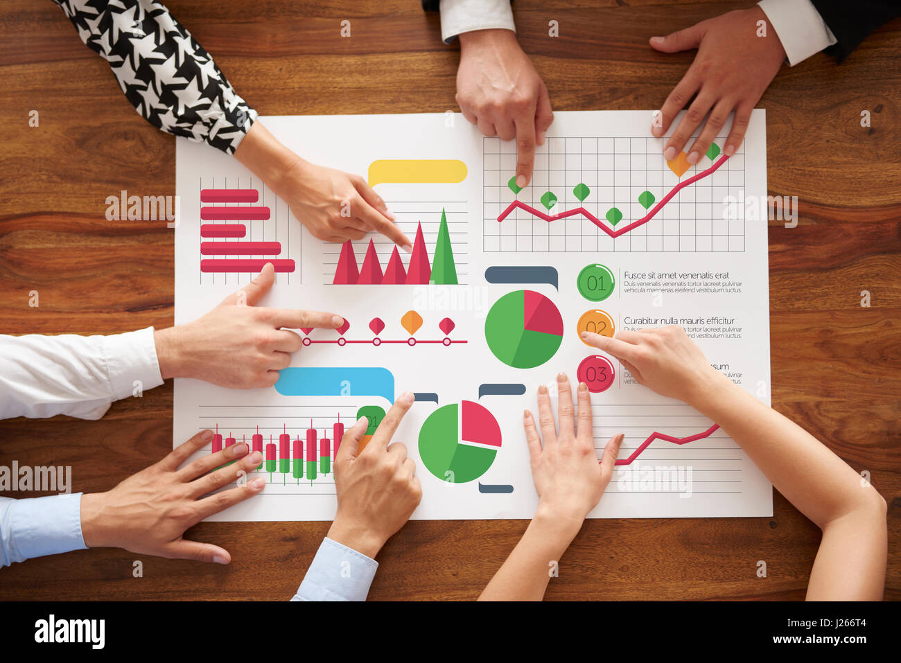 Business people analyzing many charts Stock Photo - Alamy