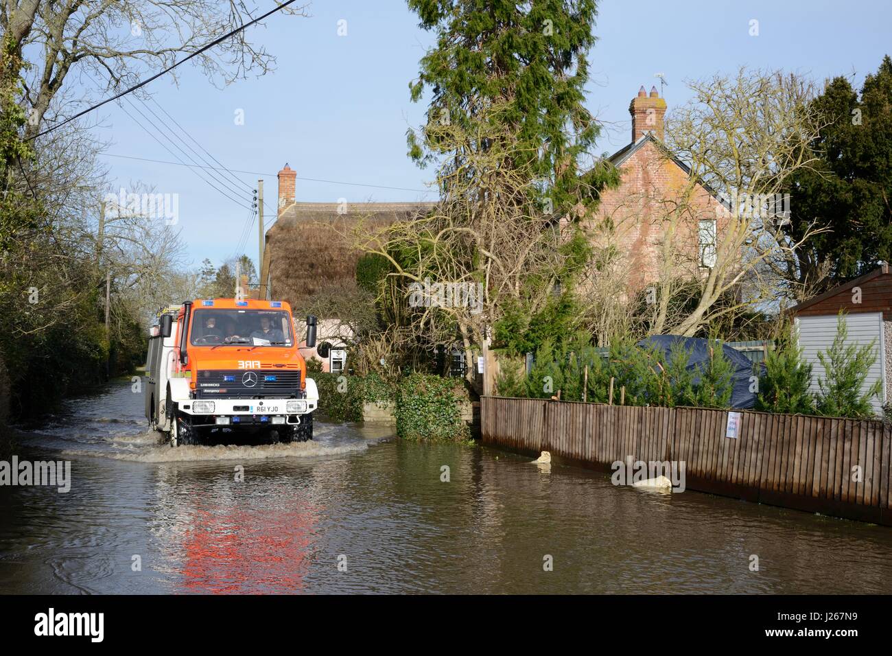 Fire engine negotiating flooded road through Thorney village after ...