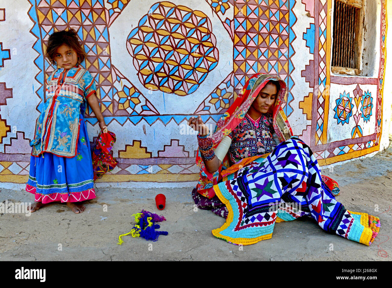 A Lambada woman doing art work on a cloth for sale Stock Photo - Alamy