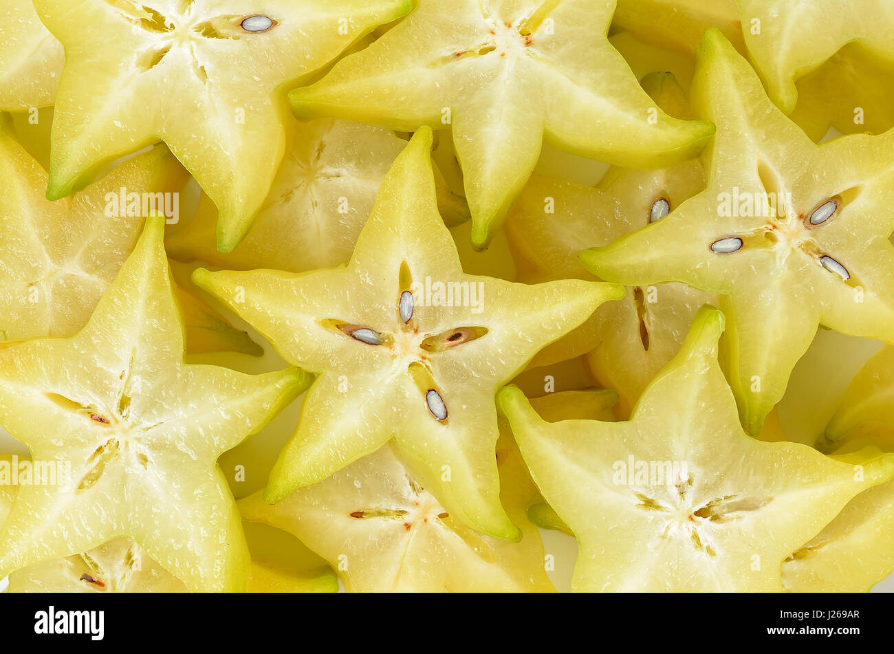 Sliced star apple on white background Stock Photo - Alamy