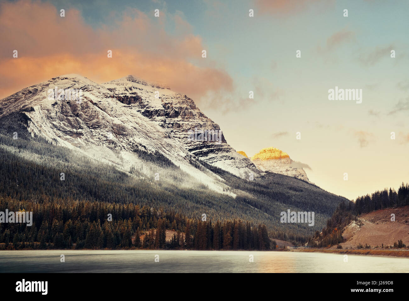 Mountain lake with reflection and fog at sunset in Banff National Park ...