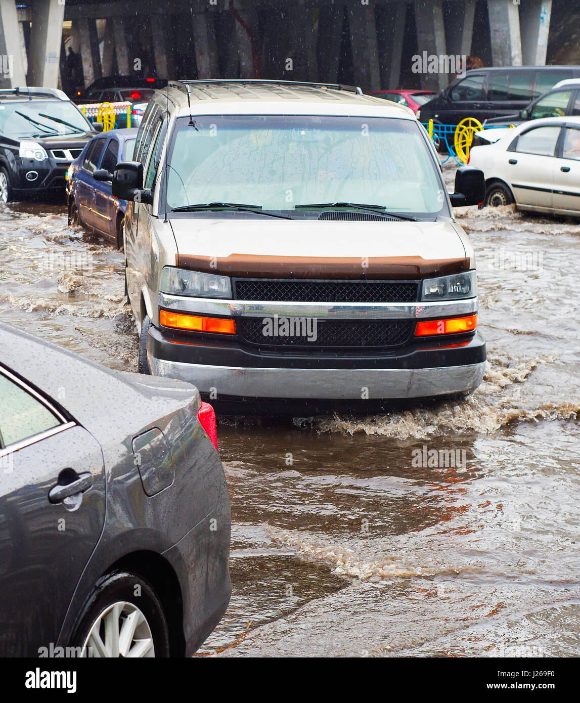 Heavy traffic on a flooded city road in the rain Stock Photo - Alamy