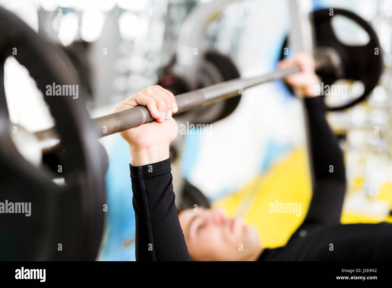 Closeup of young handsome male doing exercises on a bench press Stock ...