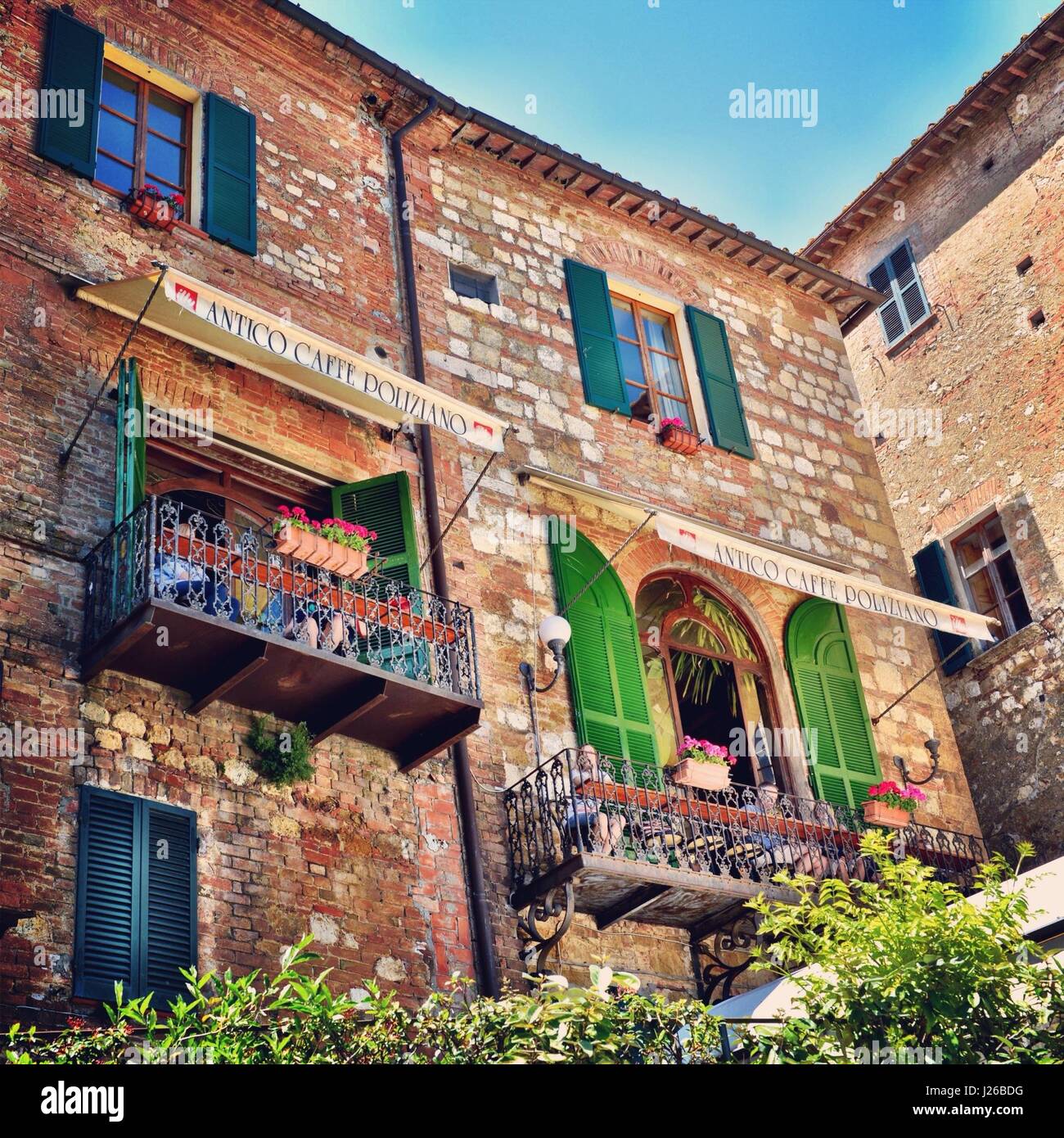 People sitting on cafe balcony, Tuscany, Italy Stock Photo - Alamy