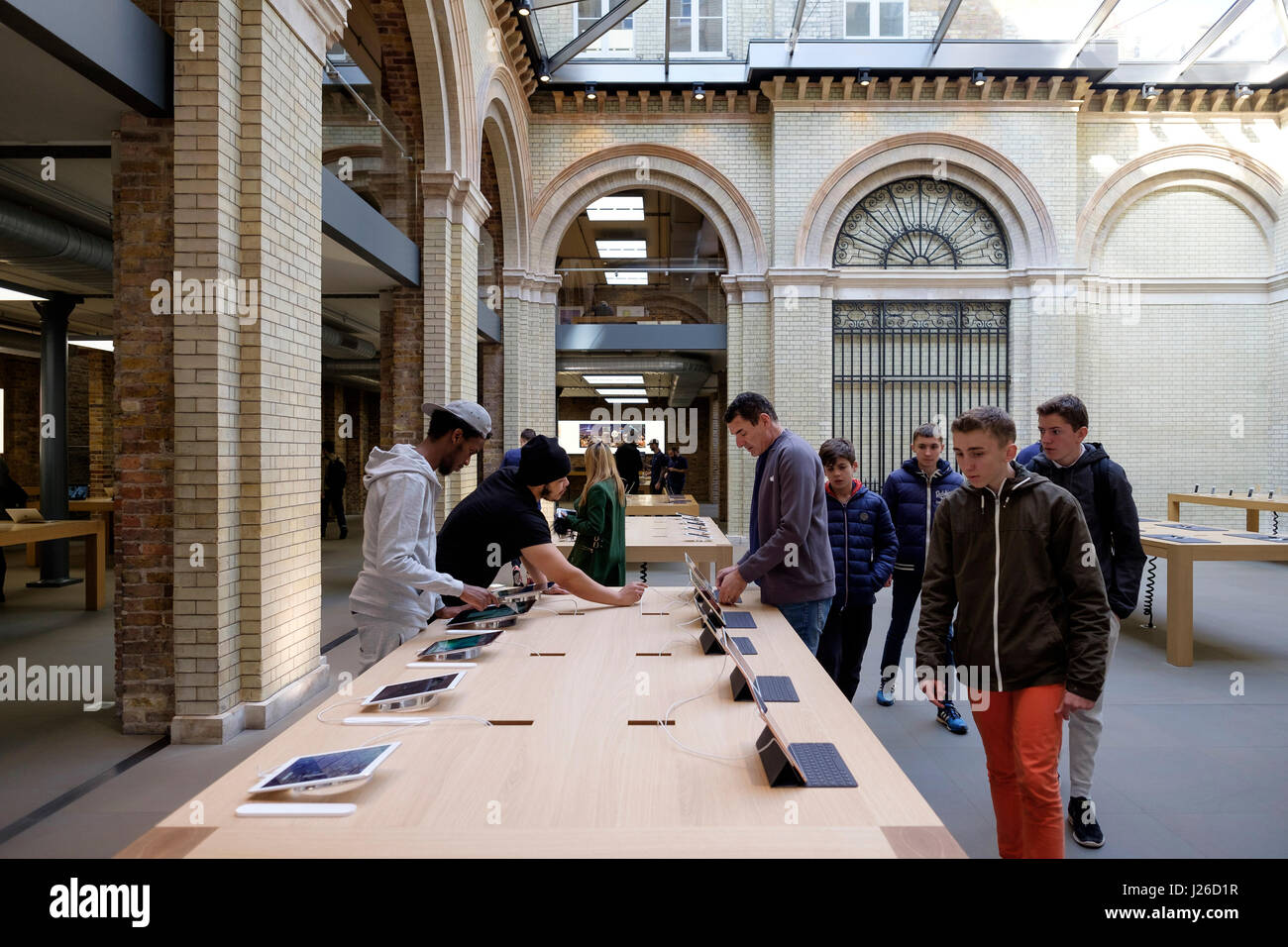 Costumers browsing Apple products at the Apple store located on Covent ...