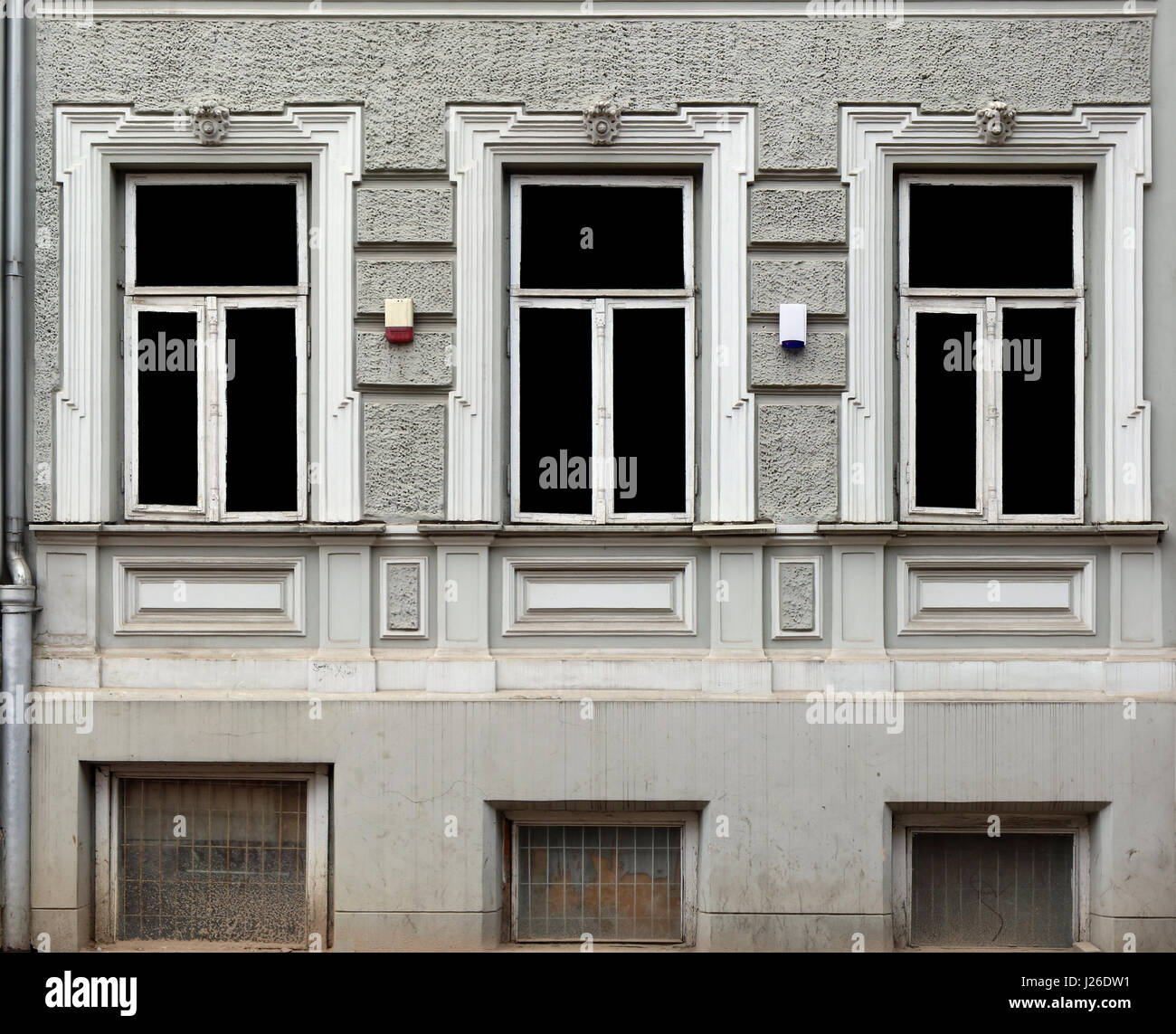 Three windows with decorative stone frames in the house stylized by a ...