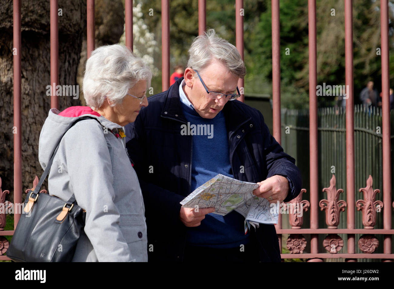 Lost elderly tourists looking at map Stock Photo - Alamy