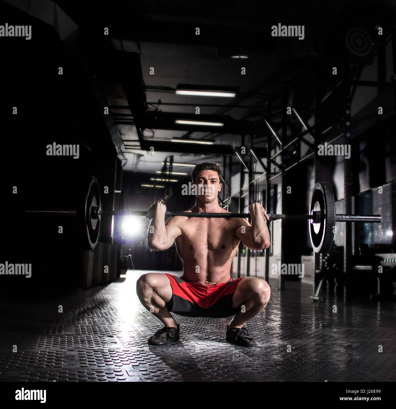 barbell front squat exercise athletic man during intense workout Stock ...