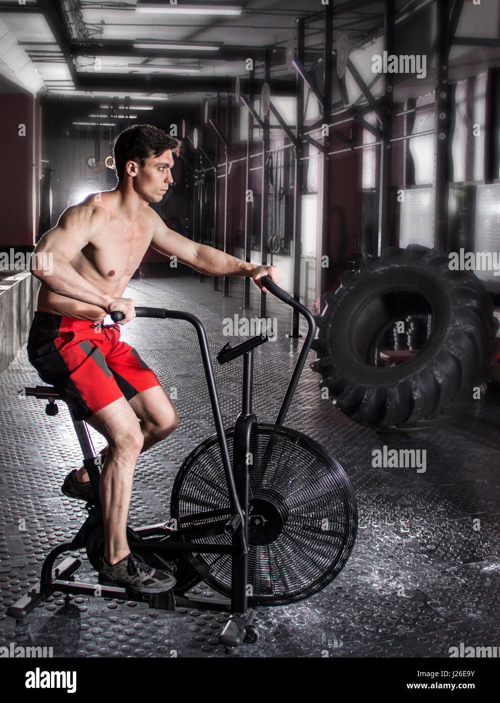 young athlete using exercise bike at the gym. Fitness male using Stock ...