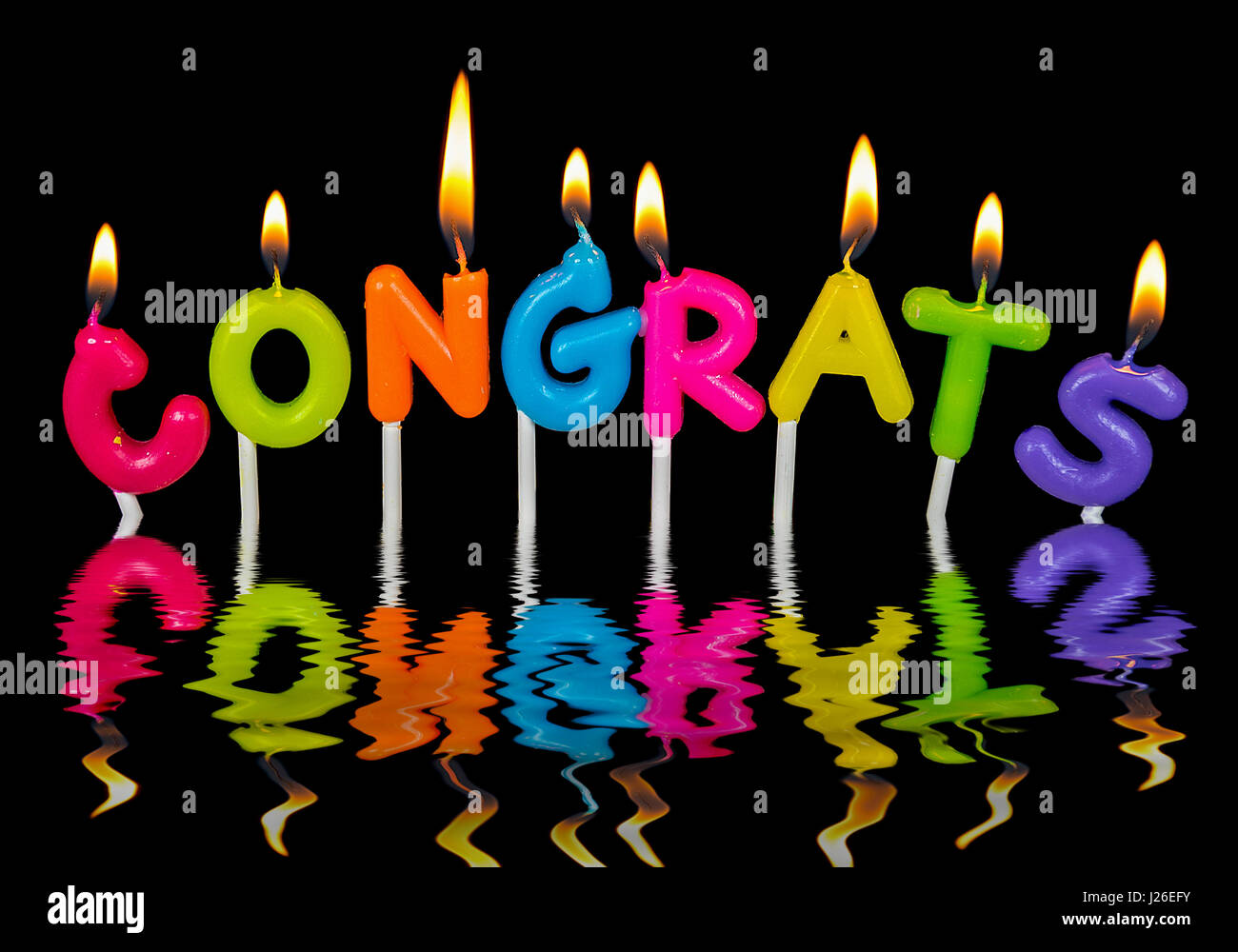 congrats candle in rippled black water reflection Stock Photo - Alamy