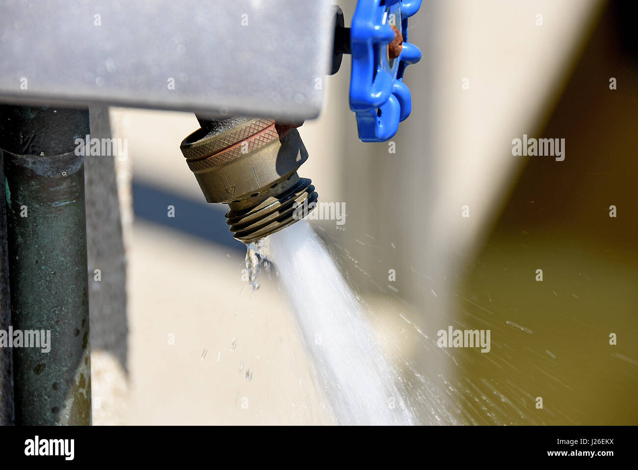 water flowing out of outdoor faucet Stock Photo - Alamy
