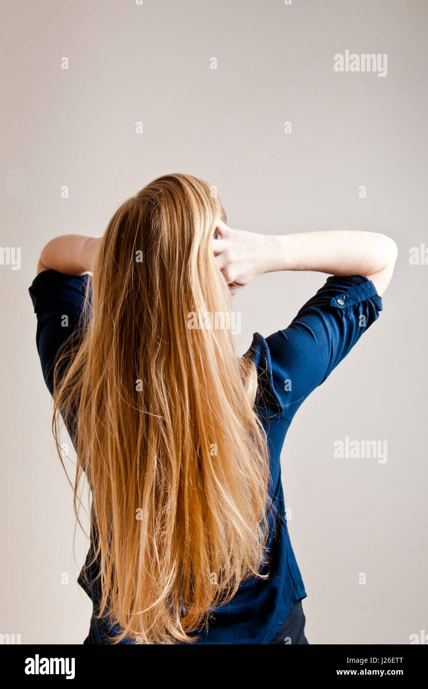 blond girl touching hair Stock Photo - Alamy