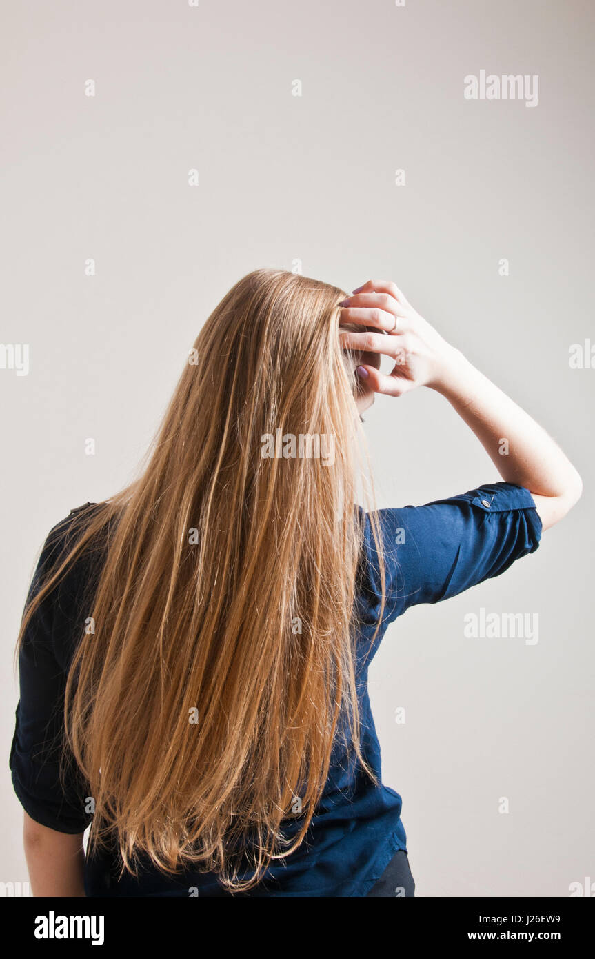 blond girl touching hair Stock Photo - Alamy