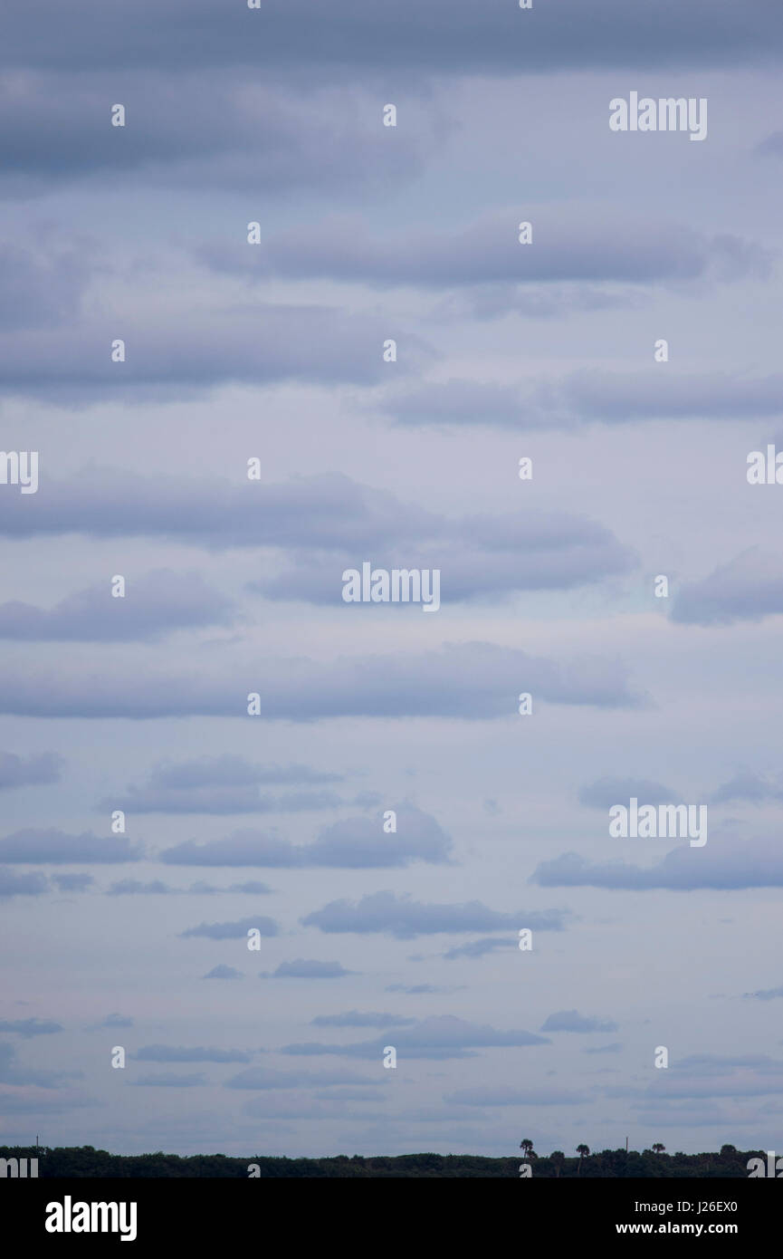 A scenic view of clouds stacked in the sky at dusk showing off a subtle ...