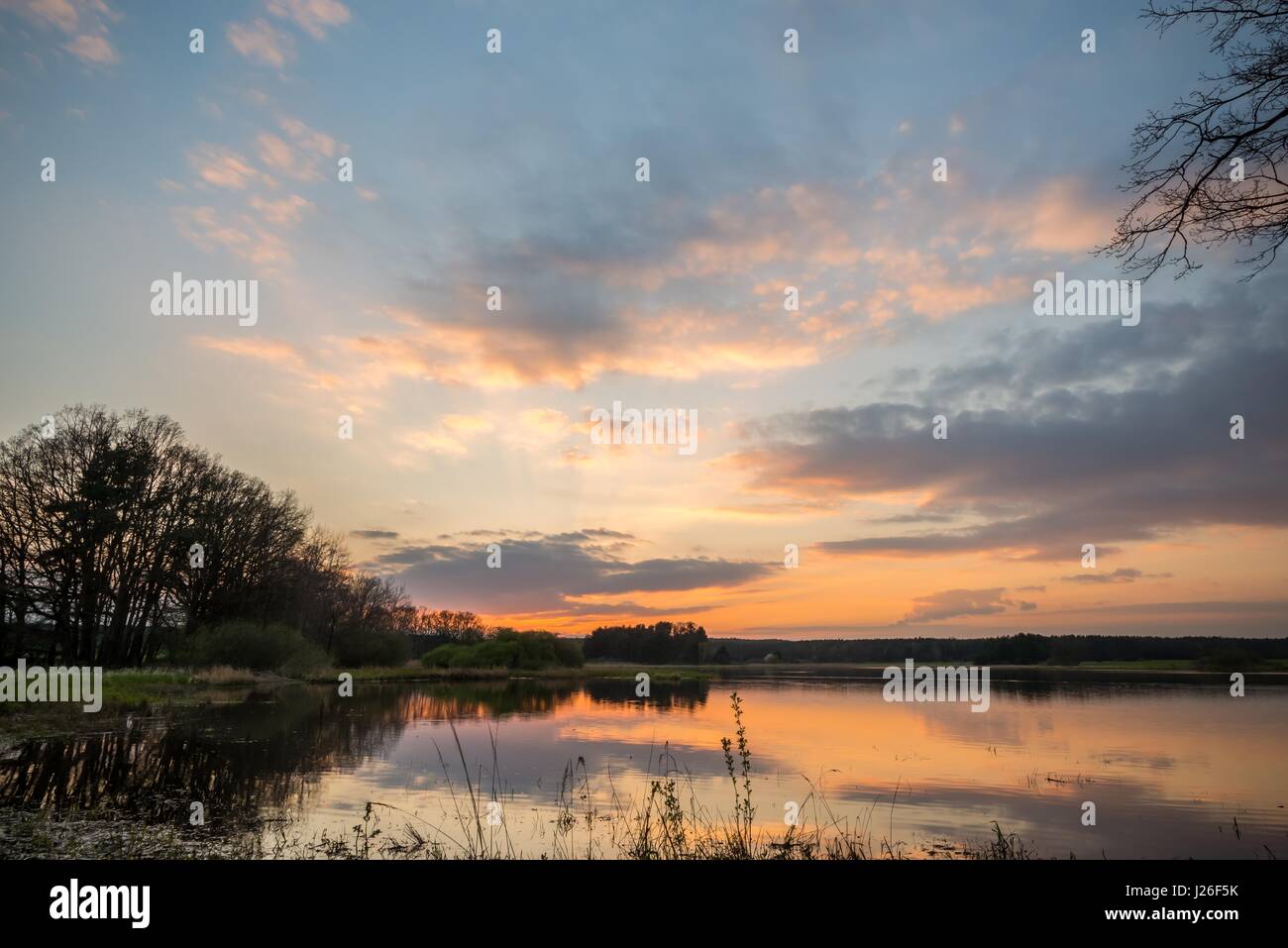Horizontal photo with spring evening landscape after sunset. Cloudy sky ...