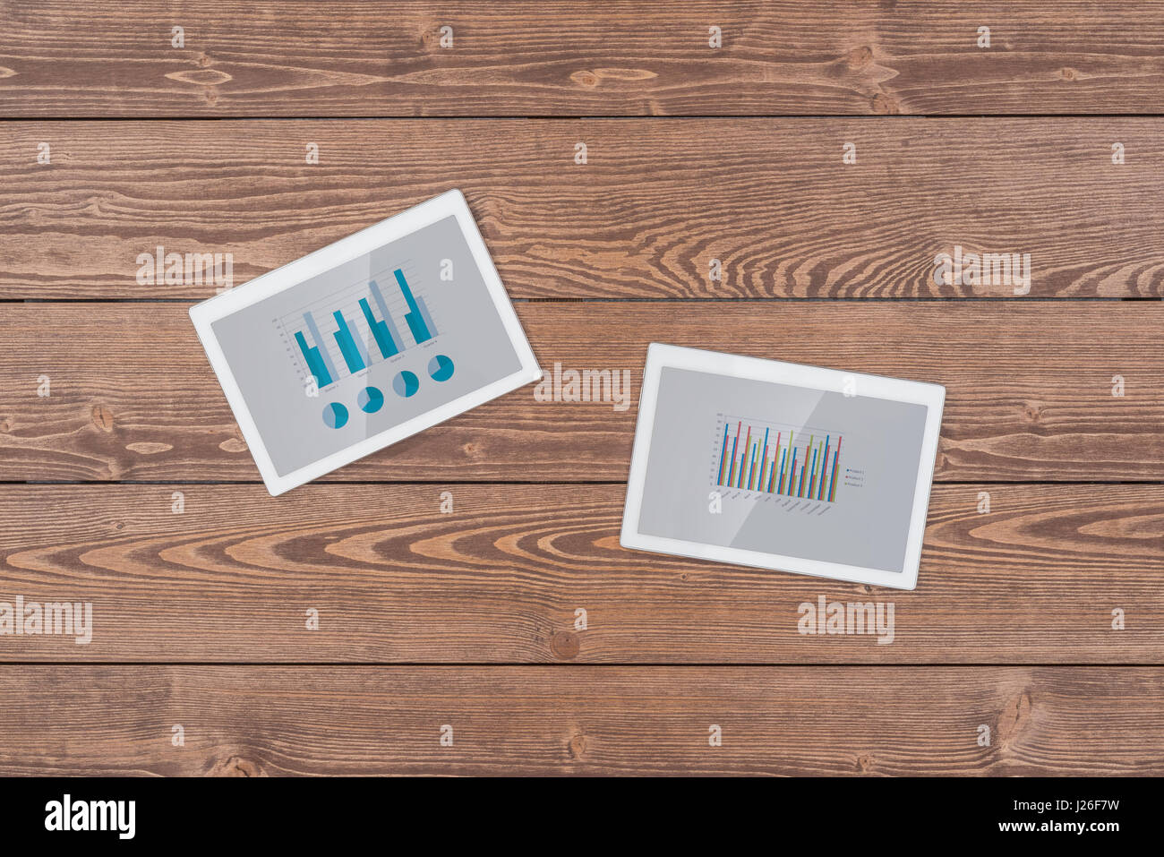 White digital tablets on wooden table Stock Photo - Alamy