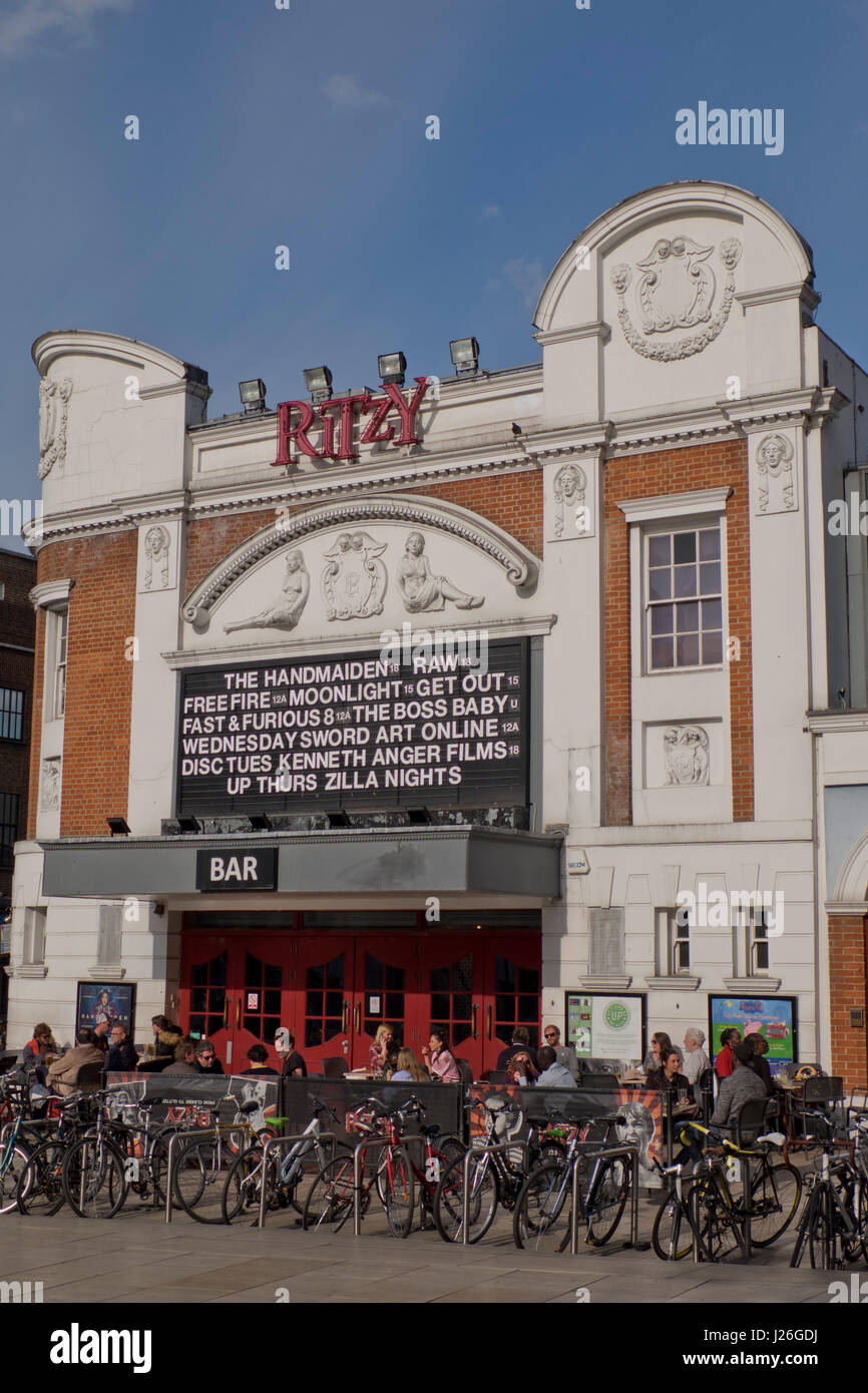 People sit outside at the bar of the Art Deco Ritzy cinema in Brixton ...